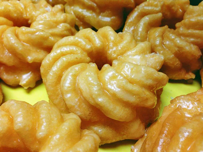 French crullers that could make a Parisian weep with joy. Delicate, airy spirals of fried perfection that practically float off the plate.