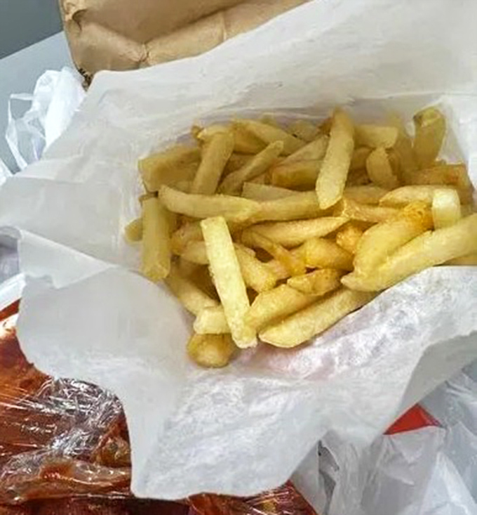 Golden fries nestled in paper &ndash; the perfect supporting actor to the BBQ star of the show, ready to soak up any wayward sauce.