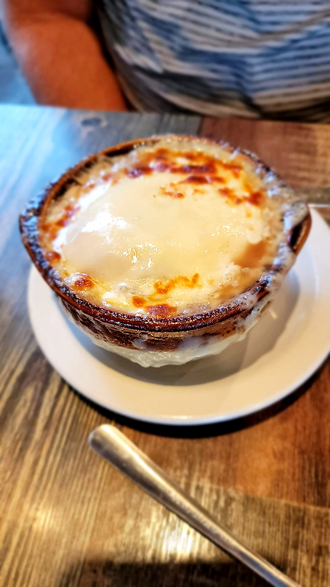 French onion soup with a golden crown of bubbling cheese&mdash;comfort food that somehow feels right at home alongside fresh seafood. 