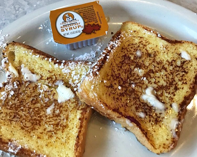 French toast dusted with powdered sugar like the first snow of winter. That melting butter creates little pools of golden goodness in every bite.