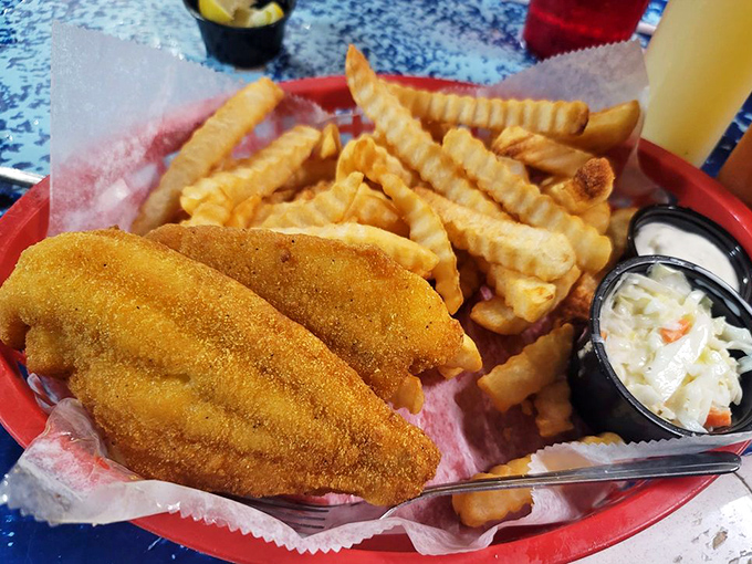 Golden-fried catfish that would make Huck Finn weep with joy, paired with crinkle-cut fries and creamy coleslaw. Southern comfort on a red basket.