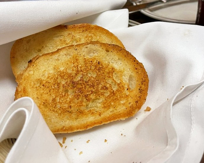 Garlic bread so simple yet perfect it makes you wonder why anyone bothers with focaccia. The golden-brown surface crackles with promise.