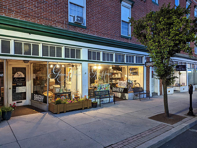 Gateau Monique's warm glow spills onto the sidewalk at dusk, beckoning passersby with promises of buttery delights.