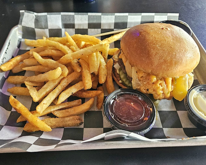 A burger that's dressed better than most people at a wedding. That brioche bun gleams like it just got a professional polish.