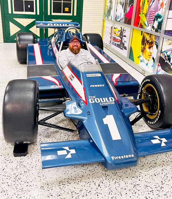 "Does this race car make me look fast?" Visitors can experience the cramped cockpit of a Penske champion firsthand.