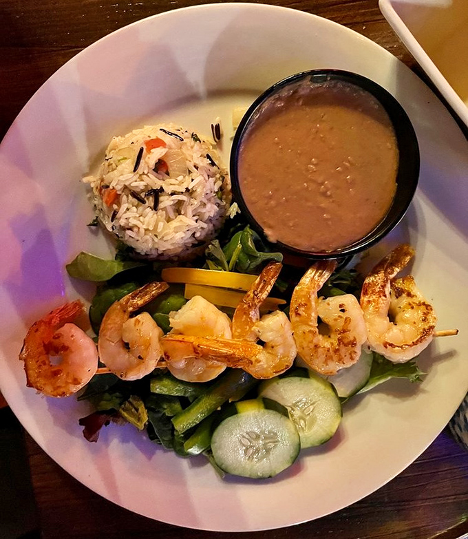 These grilled shrimp, perfectly aligned like synchronized swimmers, make a compelling case that seafood belongs in the desert after all.