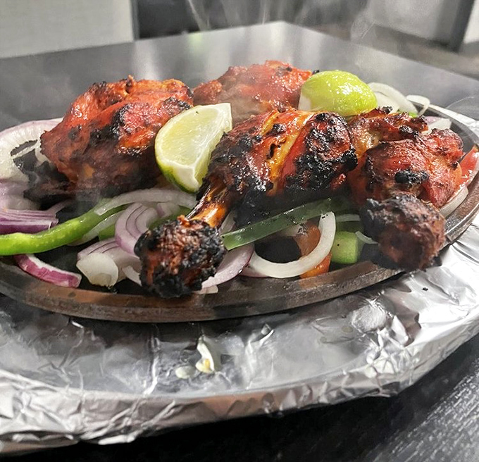 Tandoori chicken that's traveled through fire to reach your plate, bringing smoky, spicy perfection and a squeeze of lime for good measure.