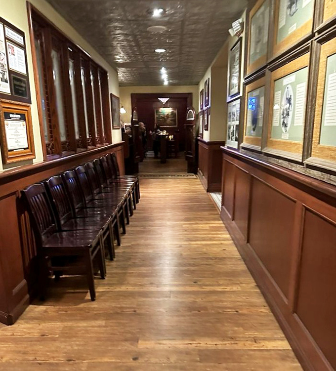 The hallway lined with historical photographs feels like a museum corridor leading to delicious rewards at the end.