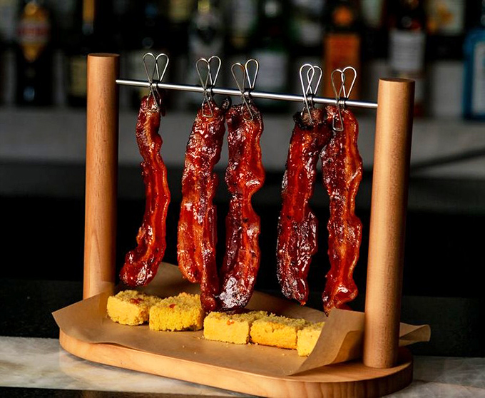 Bacon displayed like fine jewelry, because that's exactly what it is. Those cornbread squares aren't just sides&mdash;they're edible napkins for the bacon journey ahead.