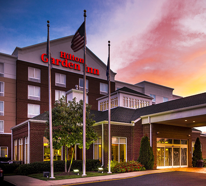 Sunset paints the Hilton Garden Inn in watercolor hues, promising comfortable beds and Hampton dreams after a day of coastal exploration.