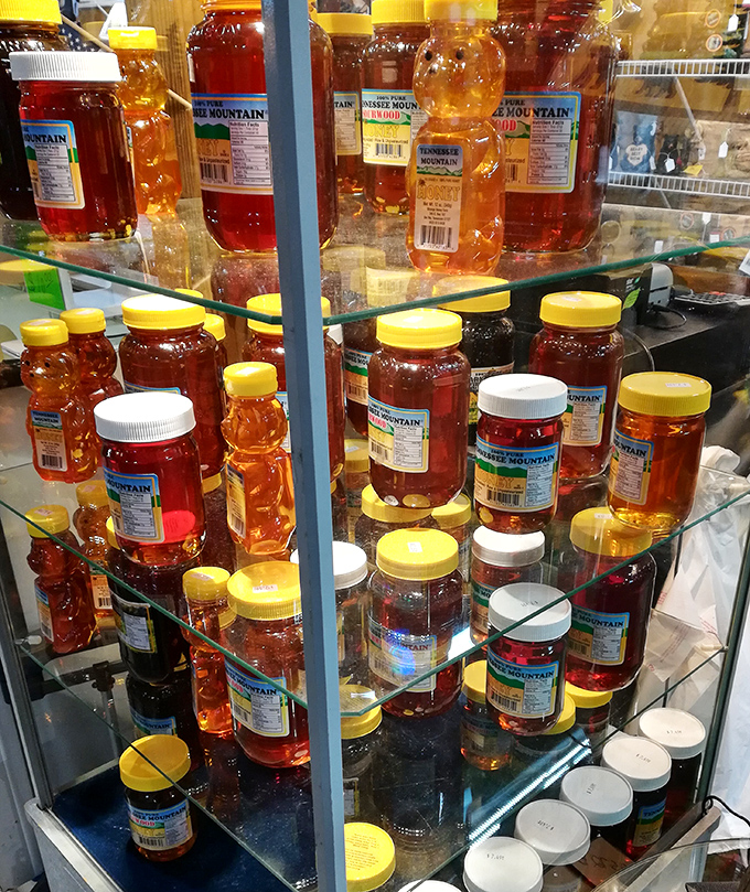 Liquid gold in bear-shaped bottles. Tennessee honey showcases nature's sweetest gift, lined up like amber soldiers behind glass.