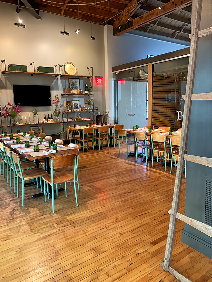 Those mint-green chair legs against warm wood floors create the kind of thoughtful design detail that makes you notice everything else about the space.