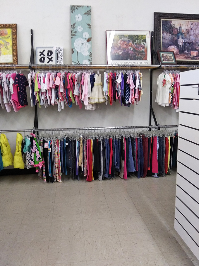 Tiny fashionistas start here! Artwork watches over miniature wardrobes where party dresses hang alongside practical play clothes for growing Floridians.