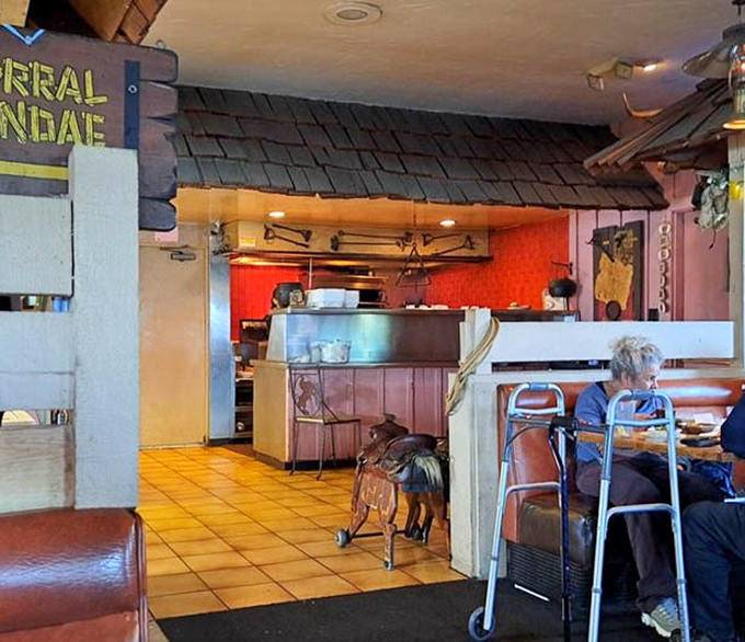 A glimpse into the heart of the operation. That saddle decoration isn't just for show&mdash;it's a symbol of the restaurant's authentic Western roots.