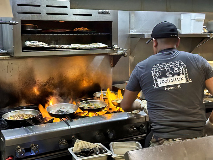 Flames dancing in the kitchen where fresh catches transform into the stuff of culinary dreams daily.