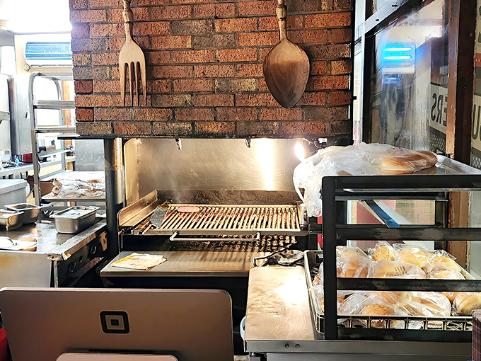 That grill has probably heard more secrets than a therapist, seasoned by decades of cooking burgers to charcoal-kissed perfection.