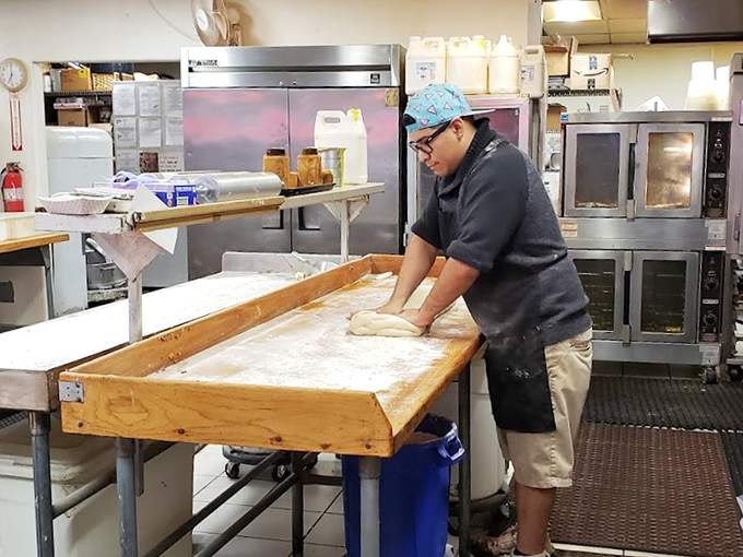 The workshop where dough becomes legend. This flour-dusted table has witnessed countless rolls come to life.