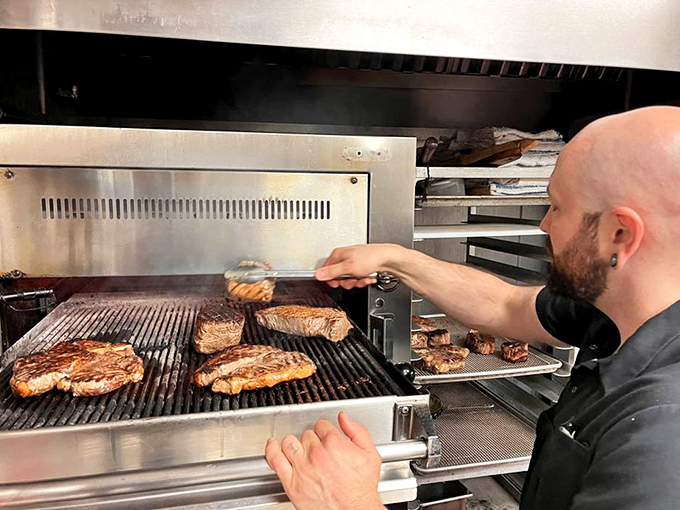 The sacred ritual of steak preparation: high heat, skilled hands, and absolutely zero fussiness. This is beef artistry in its purest form.