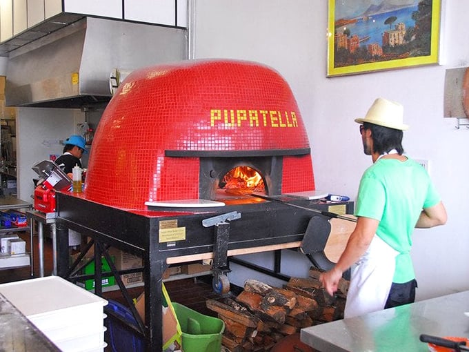 The fiery heart of Pupatella&mdash;a magnificent red-tiled oven that transforms simple ingredients into edible masterpieces at 900 degrees. 