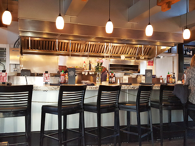 The best seats in the house? These bar stools offering front-row views of culinary craftsmanship in action.