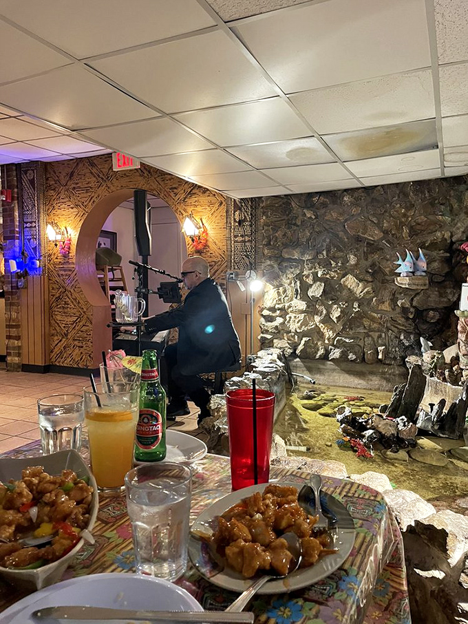 The stone waterfall wall creates ambient magic while you dine. It's like eating in a Gilligan's Island episode, but with much better food.