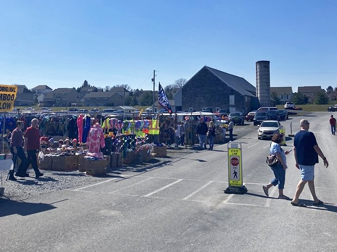 The market sprawls across the property like a small village, with shoppers navigating between outdoor stalls under the watchful eye of blue Pennsylvania skies.