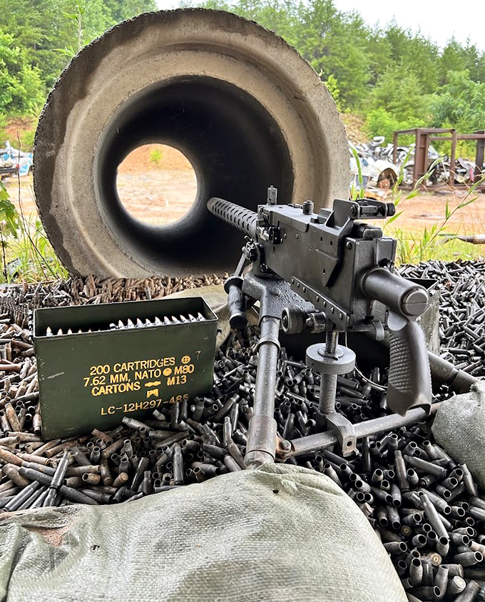 Authentic military hardware surrounded by spent cartridges creates an atmosphere of controlled chaos.