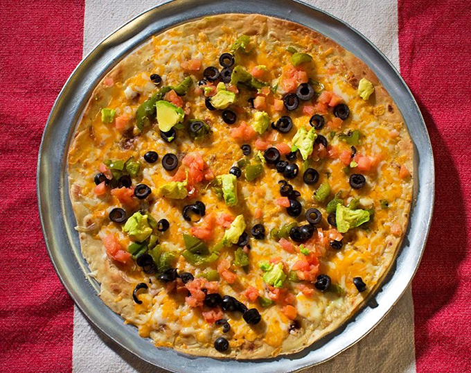 This Mexican pizza laughs at chain restaurant versions. Those fresh avocados aren't just toppings&mdash;they're a statement.