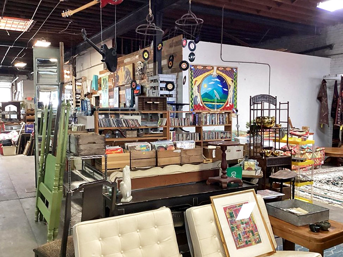 A collector's paradise where vinyl records hang like art pieces above mid-century seating that Don Draper would approve of.