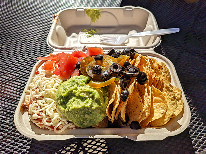 Nachos that understand the importance of proper topping distribution. That guacamole mound isn't just a condiment&mdash;it's the emerald crown jewel. 