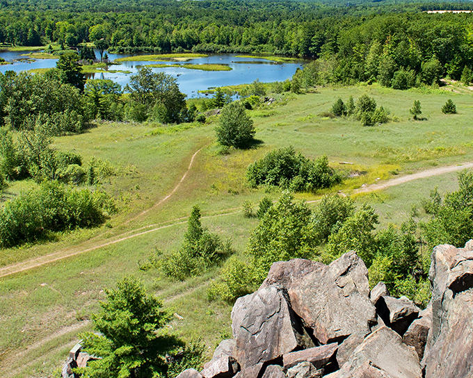 Rolling hills and inland lakes create a patchwork landscape visible from Marquette's hiking trails, where elevation rewards effort with breathtaking panoramas.