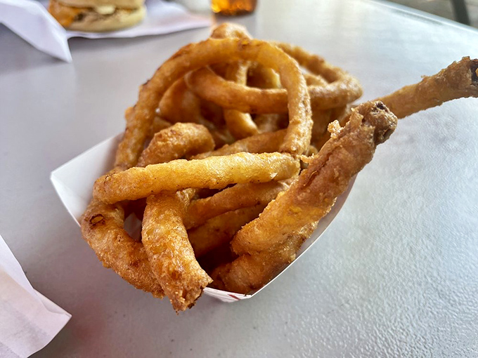 These aren't just onion rings; they're golden halos of perfection. Crispy, light batter giving way to sweet onion that makes you wonder why anyone would ever choose fries instead.