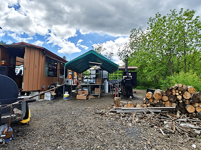 Behind the scenes where the magic happens. Wood stacked nearby hints at the authentic smoking process.