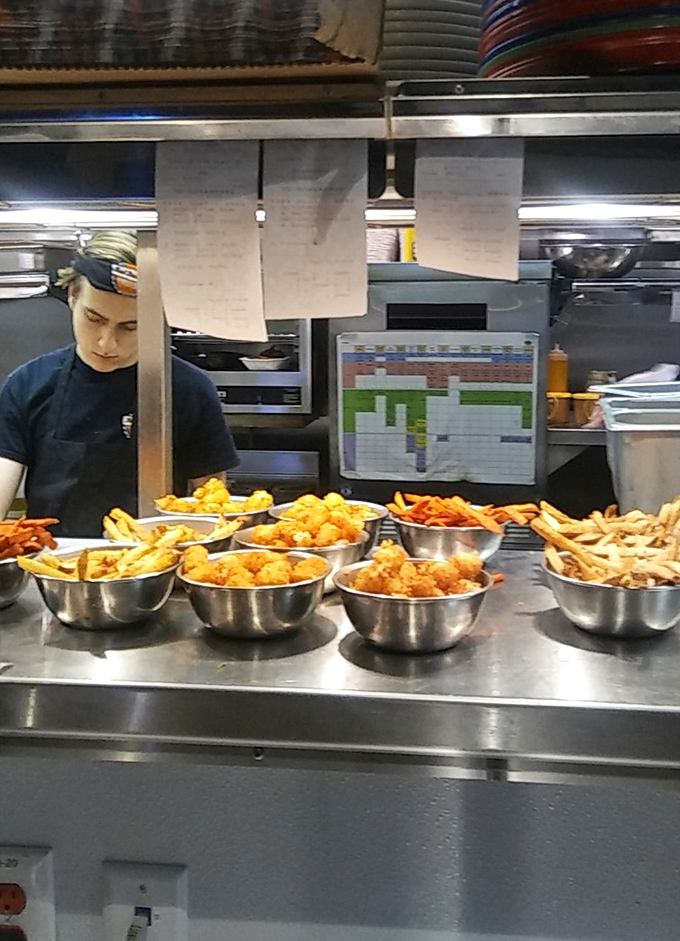 The open kitchen line-up reveals the truth behind great burgers&mdash;fresh ingredients waiting for their moment of transformation.