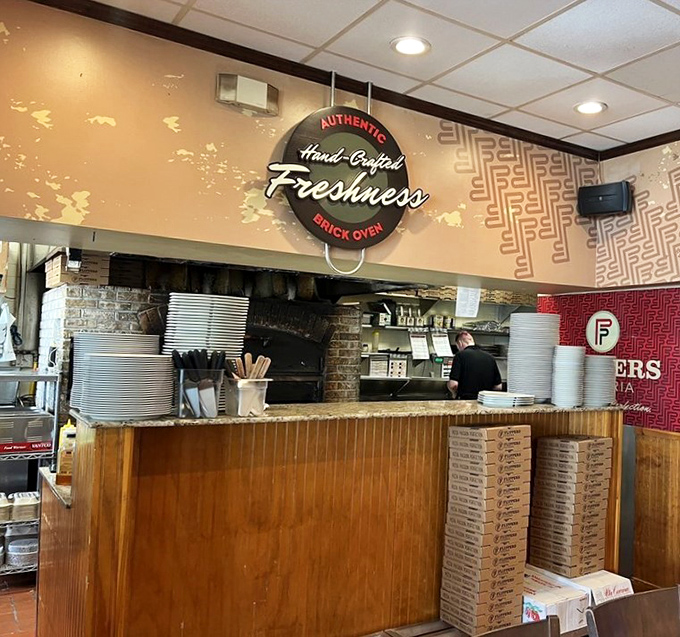 The open kitchen isn't just for show&mdash;it's pizza theater where dough-tossing artisans craft your dinner with brick oven precision.