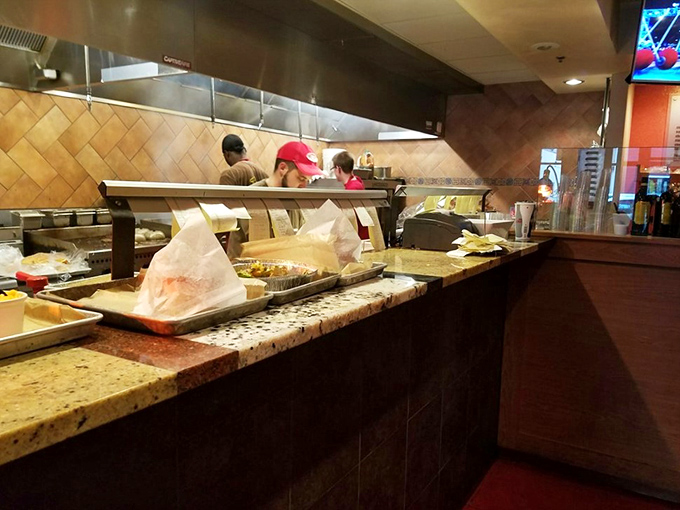 A glimpse behind the scenes where burger magic happens—the open kitchen concept that builds anticipation with every sizzle and aroma.