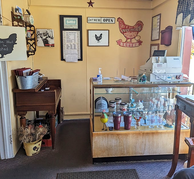Chicken-themed d&eacute;cor and a sign declaring "We're Open"&mdash;two pieces of information that together form perfect happiness. The metal chicken seems to agree.