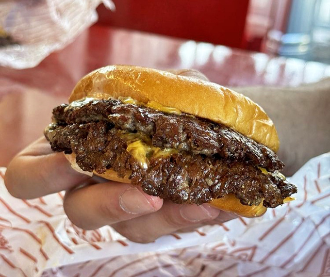 This isn't just a burger – it's a hand-held masterpiece. The way that cheese melts into every nook creates edible architecture worth studying.