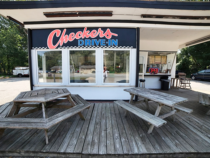 Weather-worn picnic tables tell tales of countless summer meals. These wooden veterans have supported everything from first dates to family reunions.