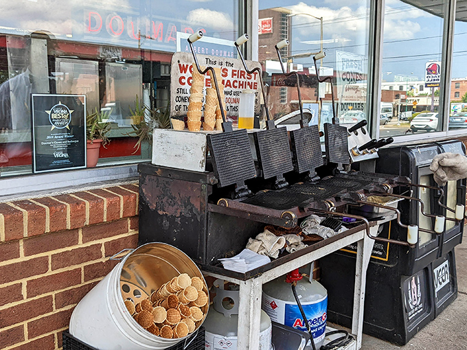 The waffle cone machine&mdash;mechanical poetry in motion. This contraption has been turning ordinary waffle batter into handheld ice cream vessels since before your grandparents' first kiss.