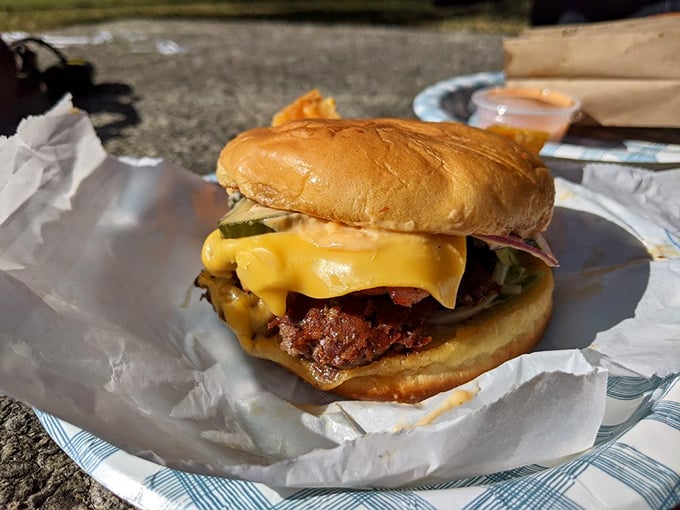 Sunshine gleams off this perfectly constructed burger like it's being photographed for a magazine cover. Even Mother Nature wants to highlight this masterpiece.