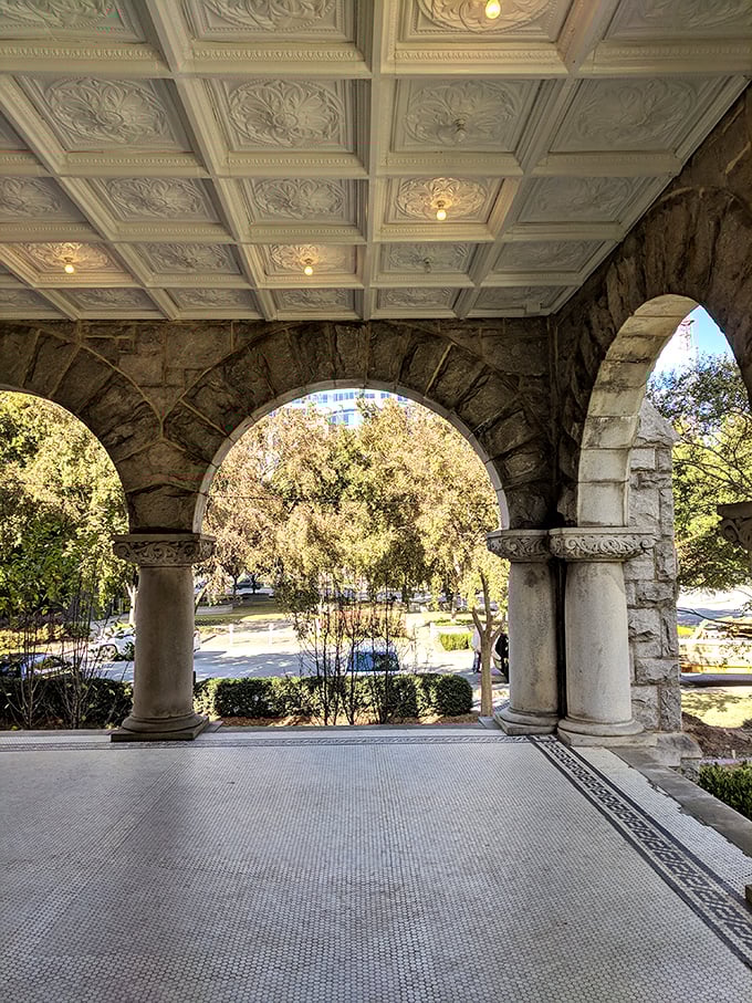 The covered porch with its perfect arches offers a shaded retreat. Those coffered ceilings are architectural eye candy you can enjoy while escaping Georgia's summer heat.
