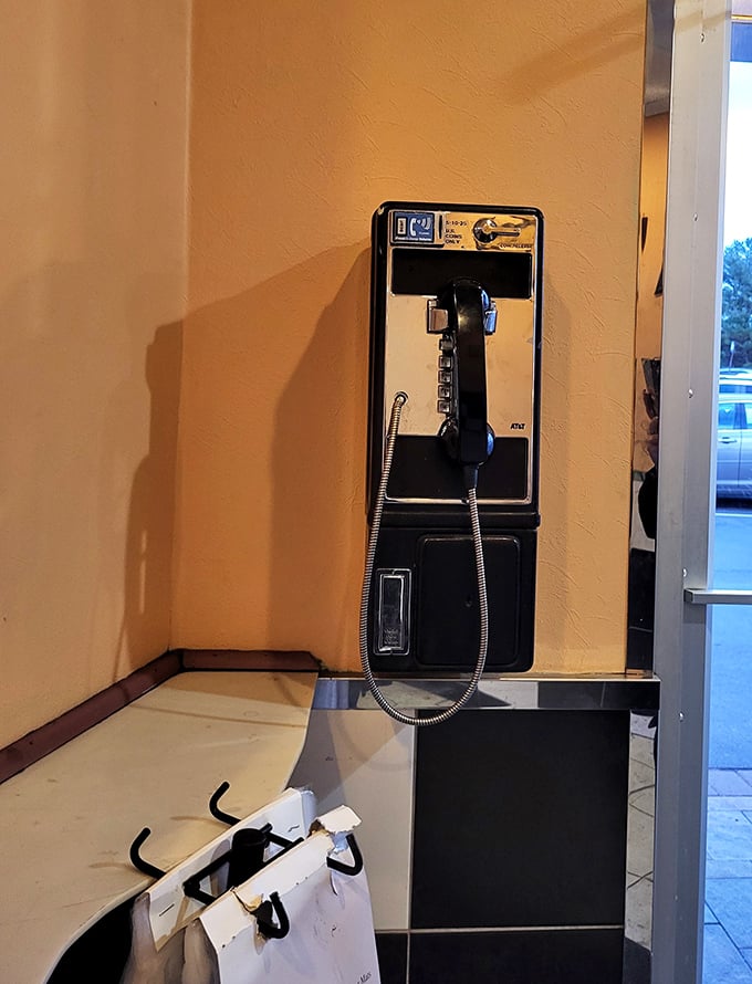 A payphone on the wall&mdash;perhaps the most honest indication you've found an authentic diner experience that refuses to completely surrender to modern times.