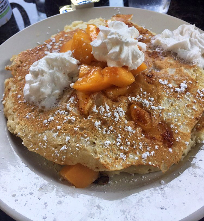 Peaches and cream pancakes that make fruit count as breakfast. Those golden cakes with their crown of whipped cream could convert any pancake skeptic.