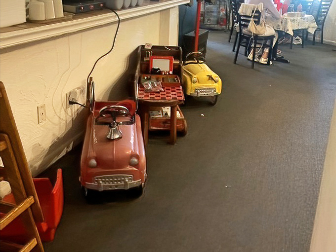 Vintage pedal cars line the wall, reminding us of simpler times when both toys and restaurant portions were built to last.