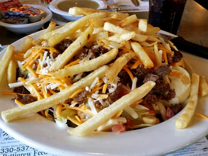 A mountain of fries atop a Philly creation that laughs in the face of sensible portions. Diet culture has no power here.