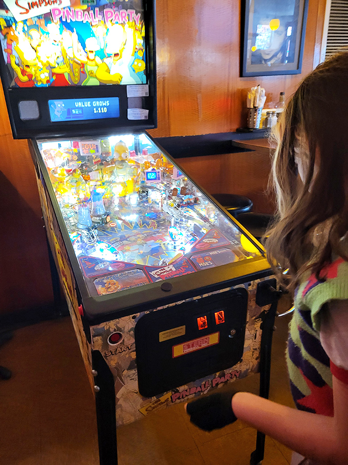 Between bites, challenge friends to pinball glory. The Simpsons machine offers nostalgic entertainment that pairs perfectly with creative comfort food.