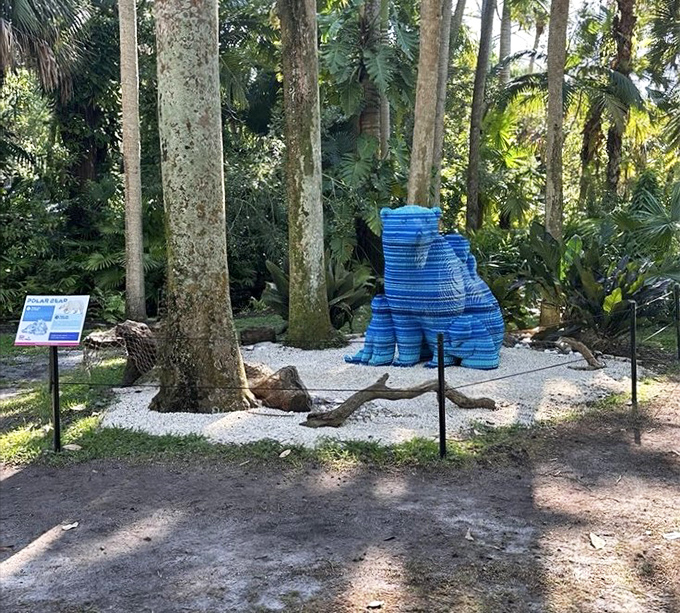A blue bear contemplates its surroundings. This playful sculpture proves art and nature make the perfect Florida cocktail.