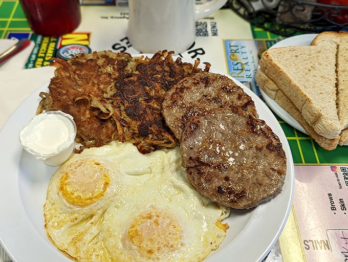 The breakfast trinity: perfectly cooked eggs, golden potato pancakes, and a sausage patty that means business. Simple food done extraordinarily well.