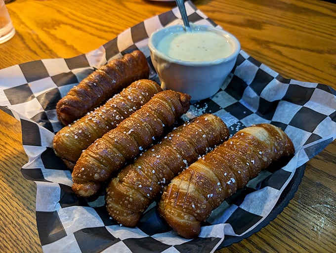 These pretzel breadsticks arrive hot, salty, and demanding to be dunked in the accompanying creamy dip without delay.